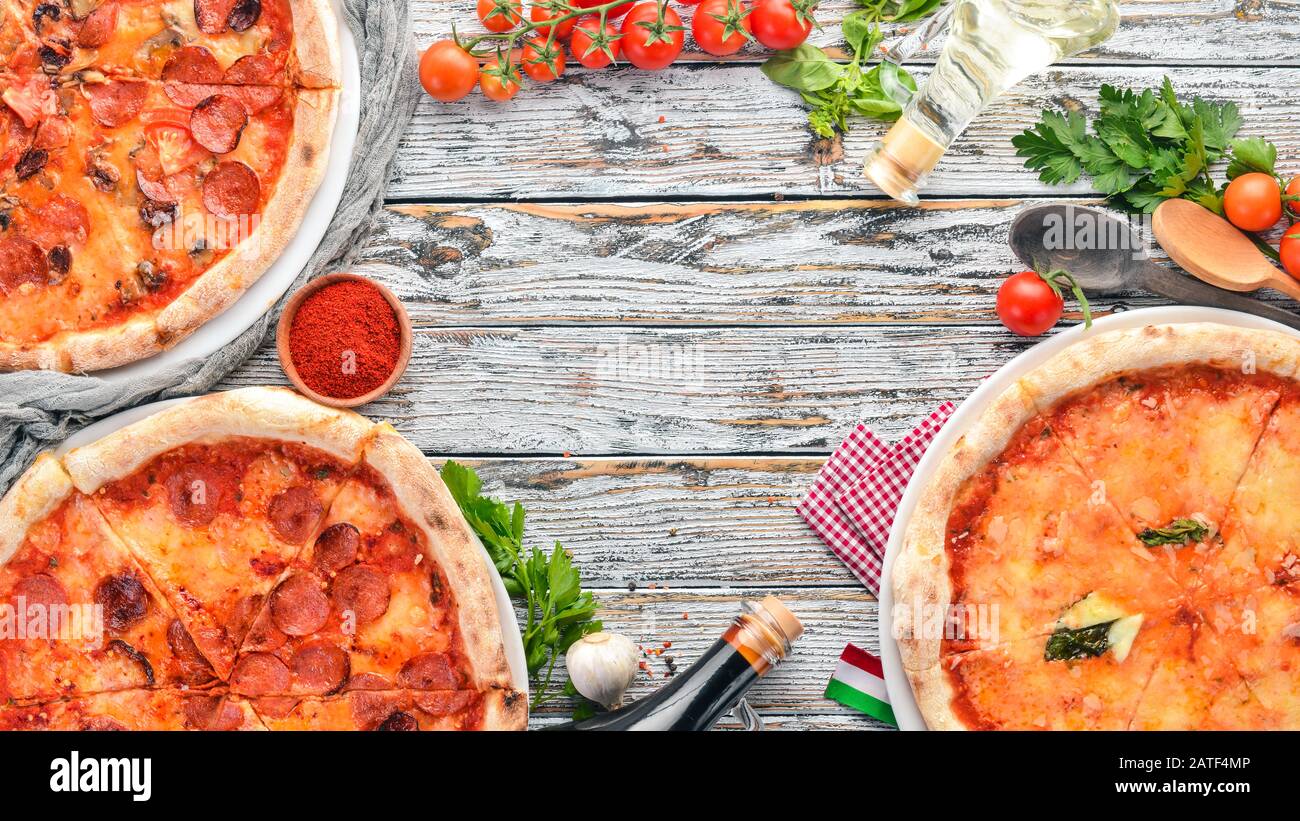 A set of Italian pizza. Italian cuisine. On a white wooden background ...