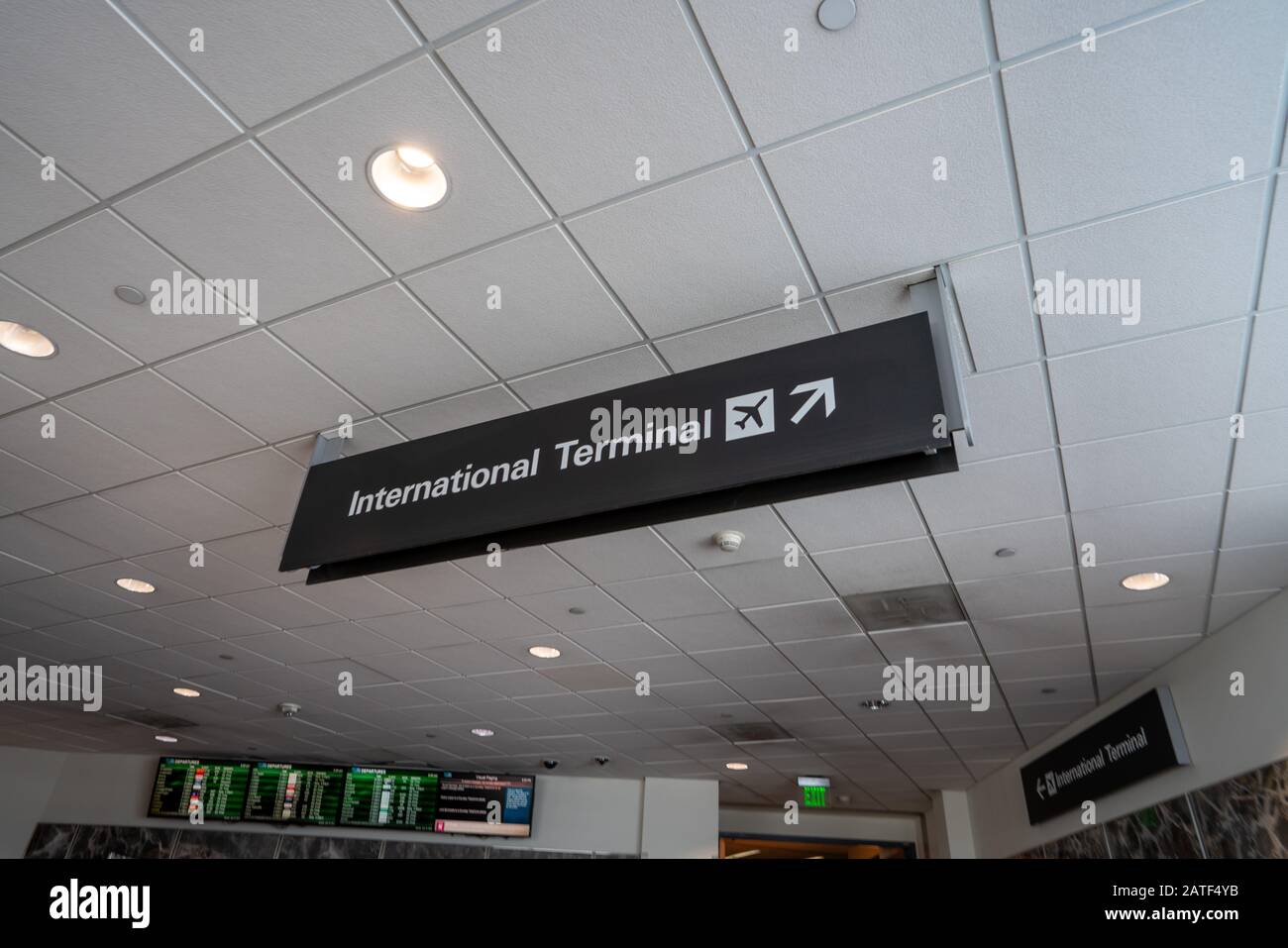 International terminal with airport logo pointing to right at airport ...