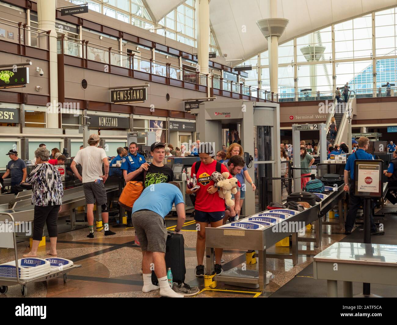 Travelers collect belongings after passing security checkpoint at ...