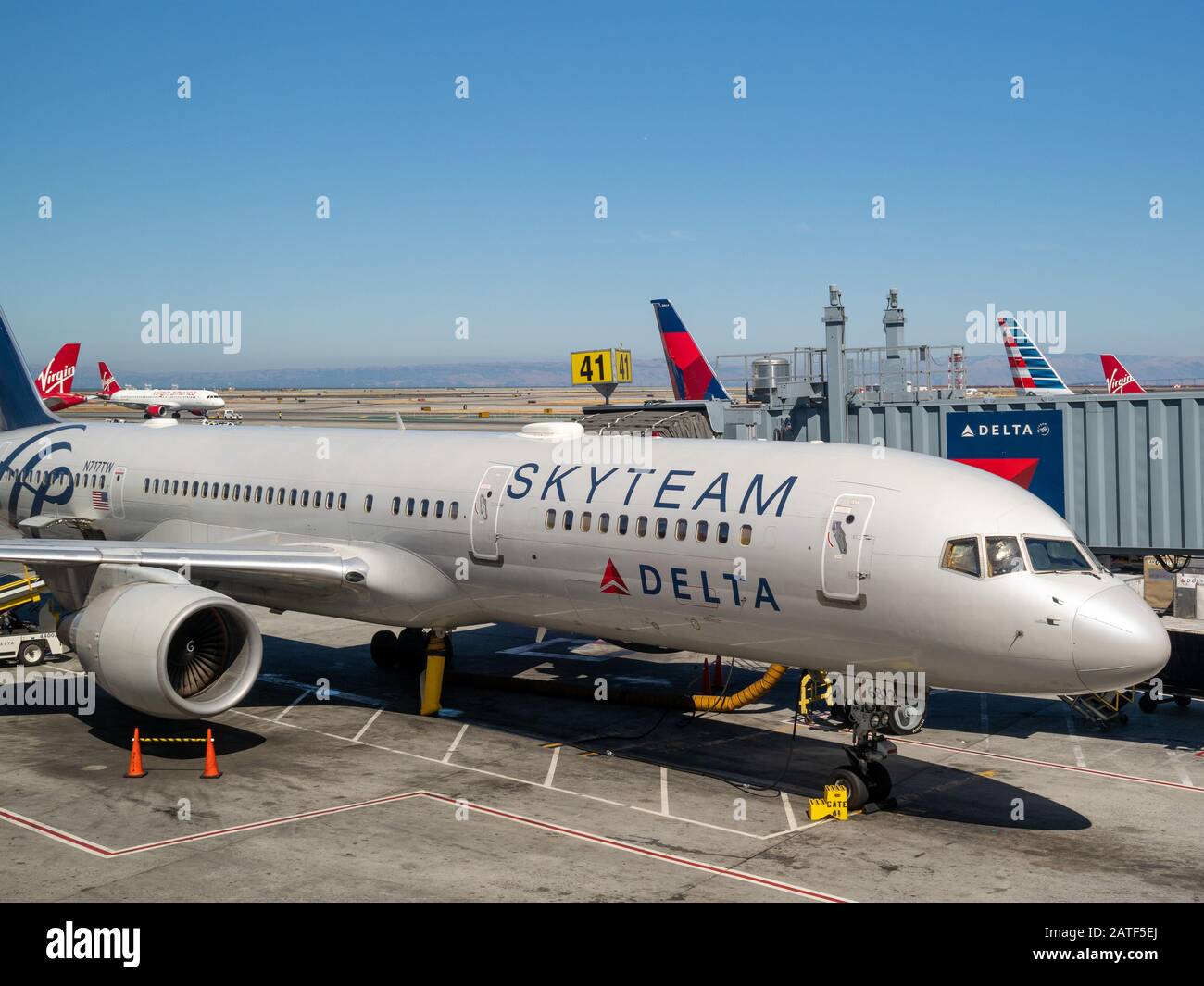 Delta skyteam plane on runway connected to terminal by a passenger ...