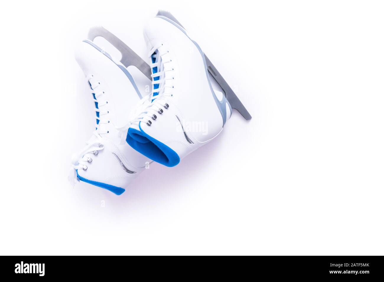 Flat lay. New white figure skates on a white background Stock Photo - Alamy