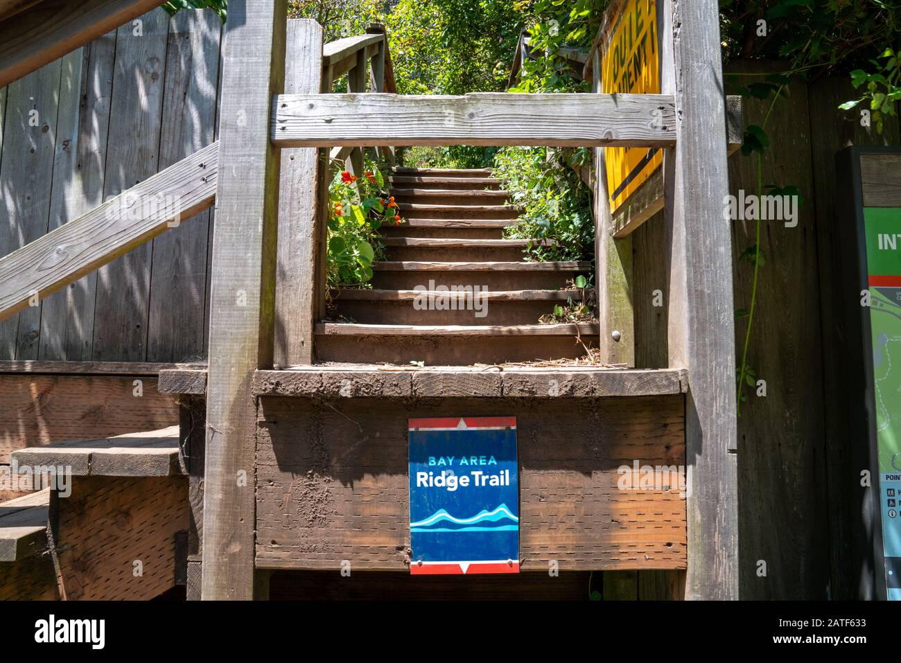 Bay area ridge trail sign posted on wooden stairs to entrance to hiking ...