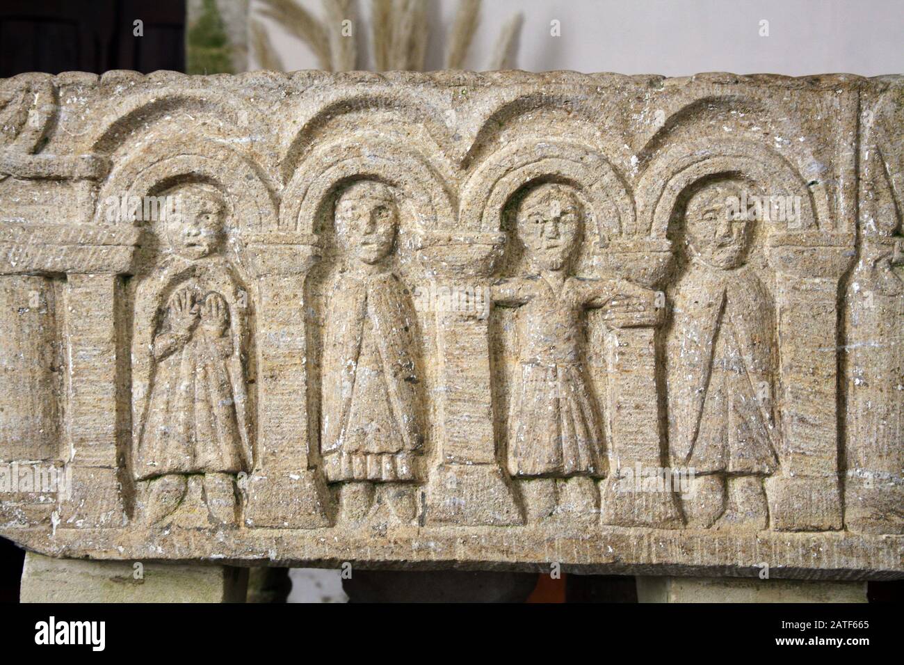 Figures carved on 12th century font in Breckles Church, Norfolk Stock ...