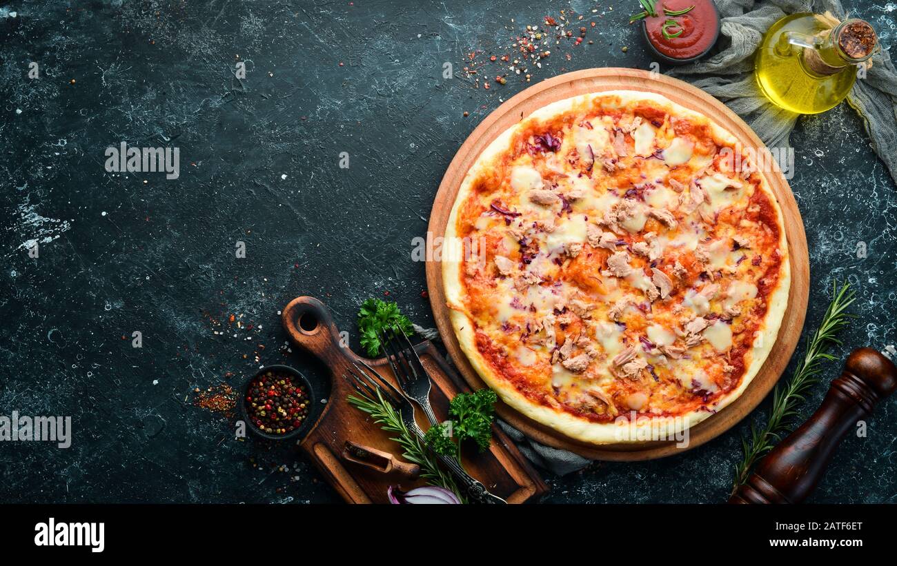 Traditional pizza with tuna and vegetables. Top view. free space for ...