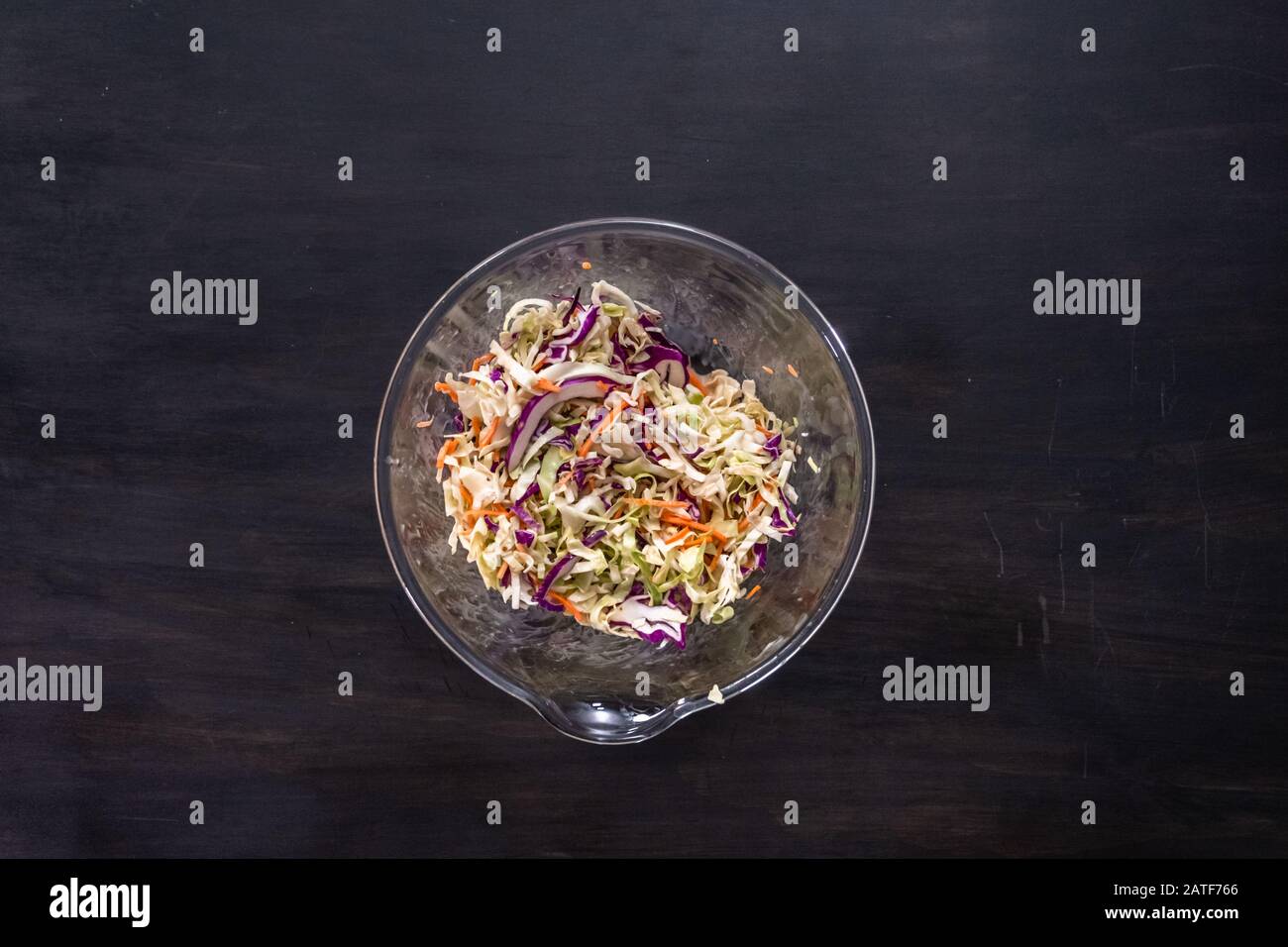 Flat lay. Making homemade coleslaw in a glass bowl Stock Photo - Alamy