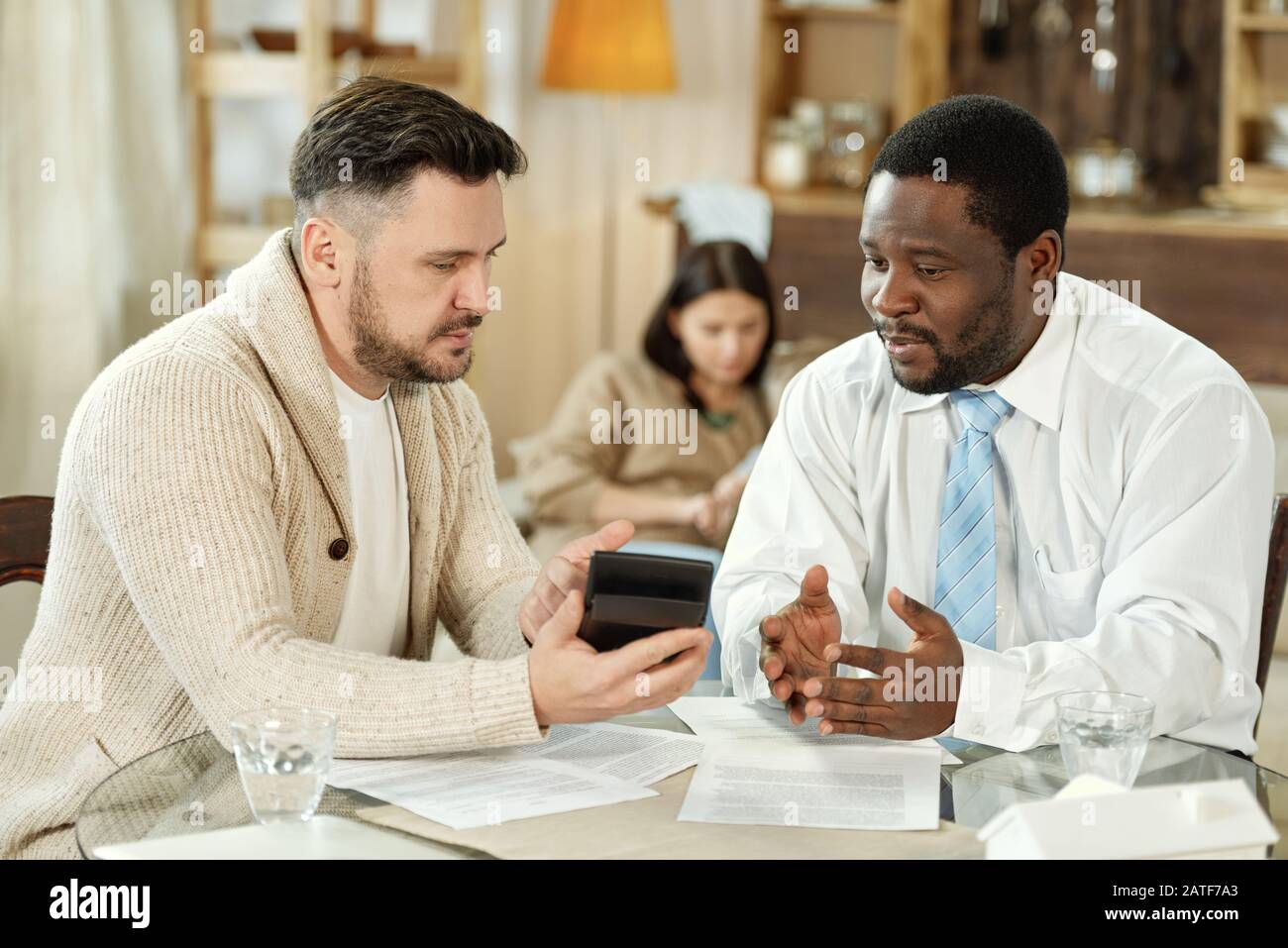 Diverse men calculating home loan on consultation Stock Photo - Alamy