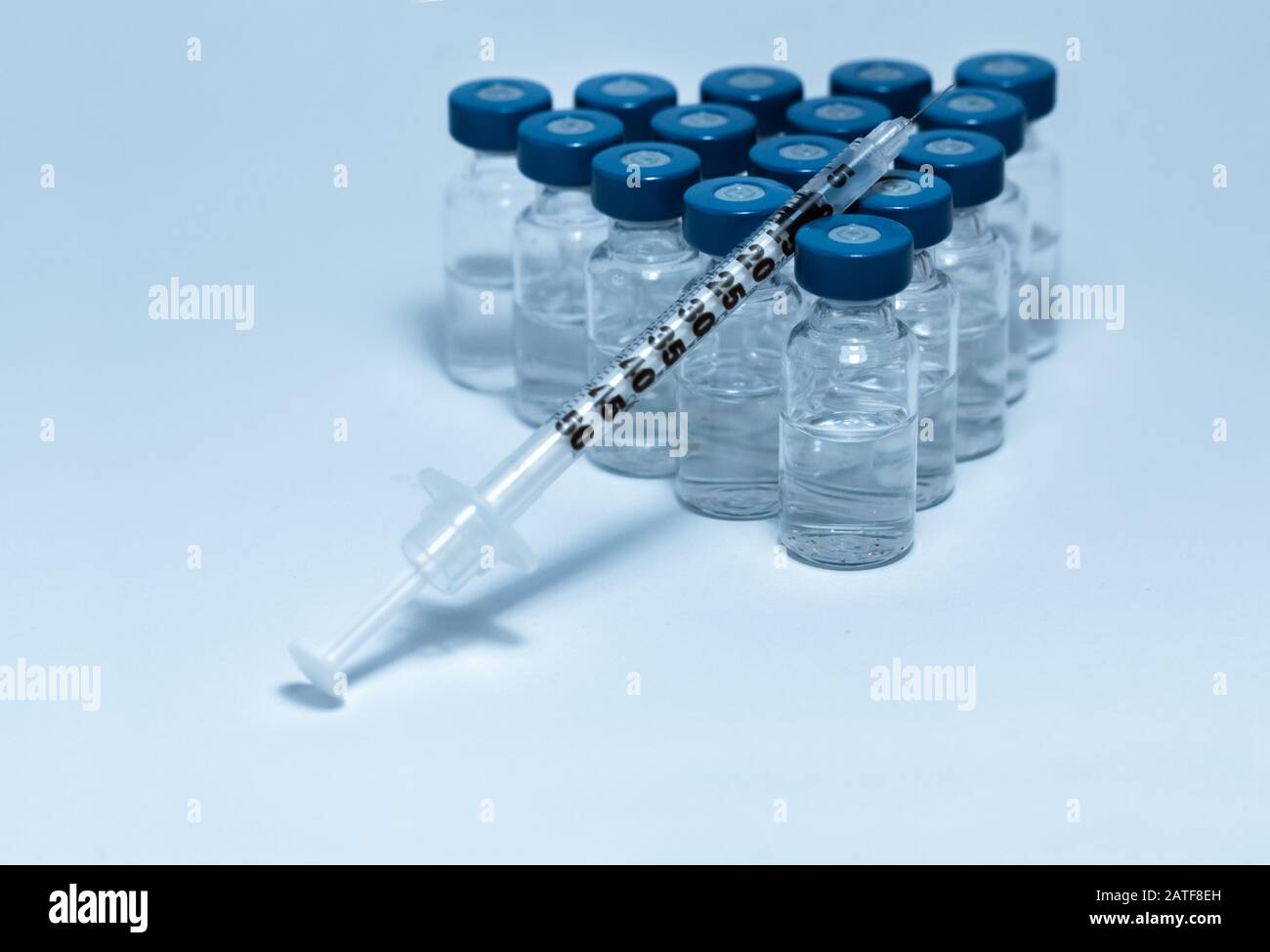 Glass medicine bottles with injection fluid with blue aluminium caps ...