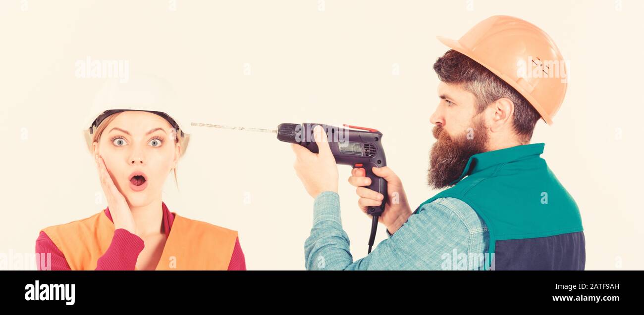 Man with drill drills head of woman, white background. Woman with ...