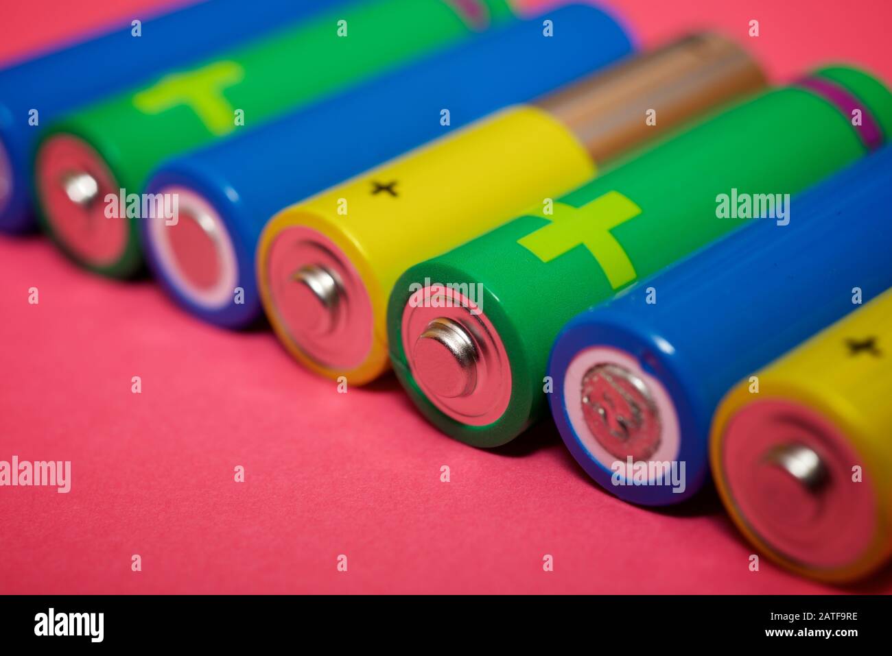 Small batteries on a pink table Stock Photo - Alamy