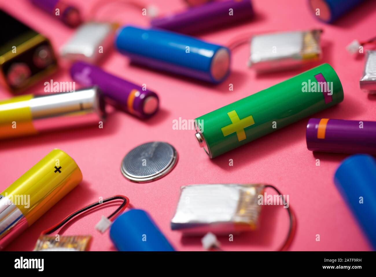Many batteries on a pink table Stock Photo - Alamy