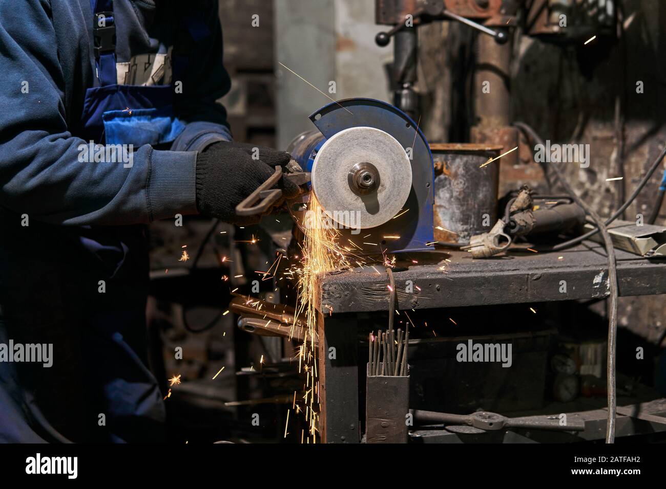 Abrasive machining manually on an power grinding wheel Stock Photo - Alamy