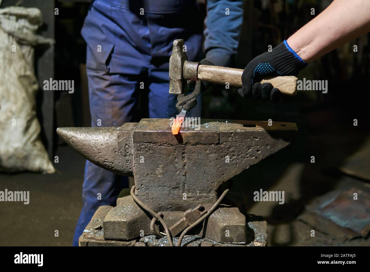 traditional forging of a hot metal billet on the anvil Stock Photo - Alamy