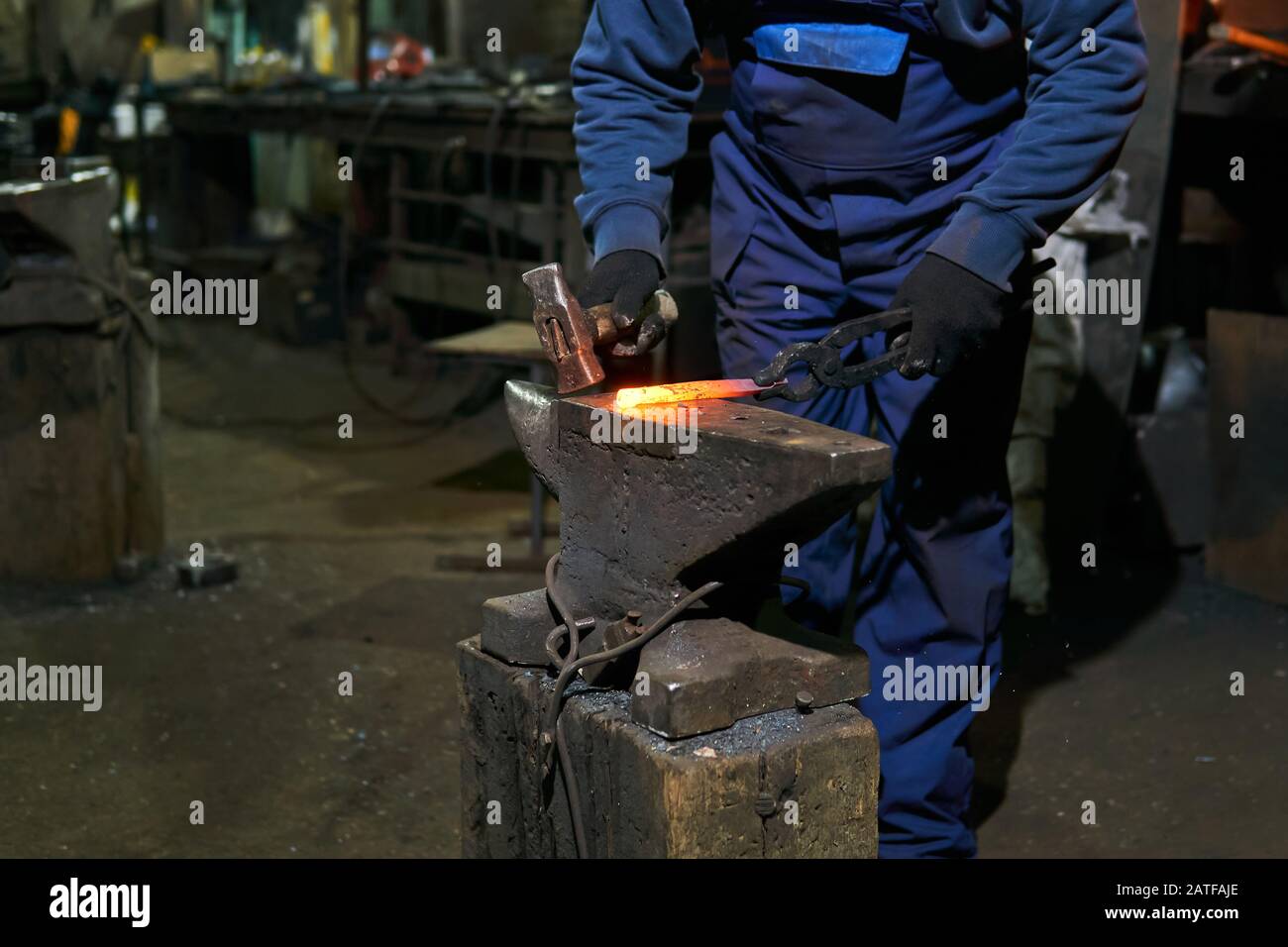 traditional forging of a hot metal billet on the anvil Stock Photo - Alamy