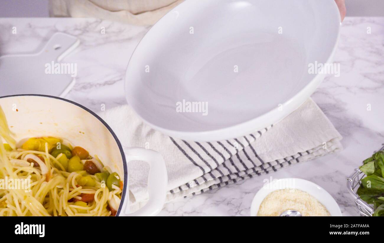 Step by step. Serving a one-pot pasta into a white pasta plate Stock ...