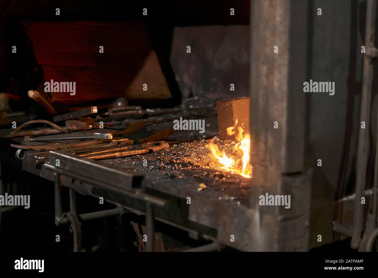 forge furnace with burning flame and blacksmith tools close-up Stock ...