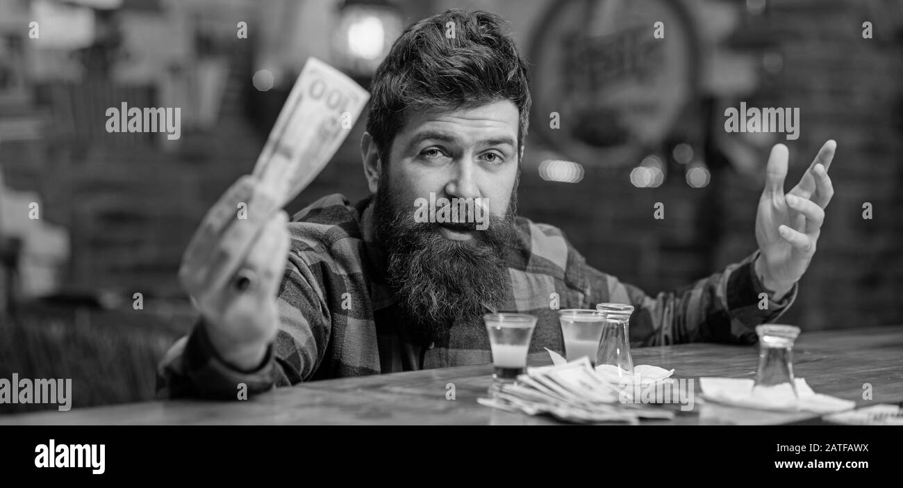 Hipster holds money, cash to buy more alcohol. Man with drunk face sit ...