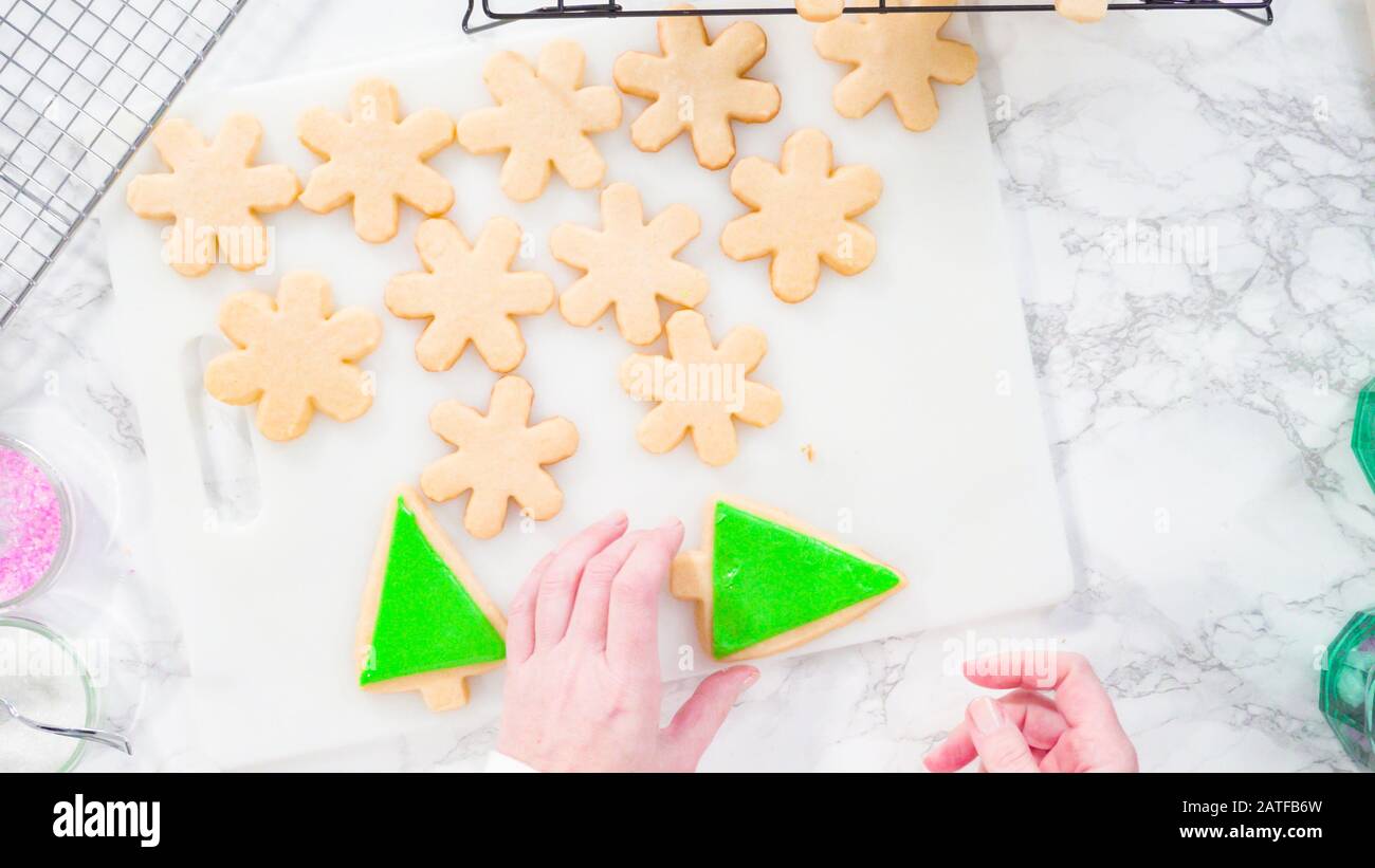 Flat lay. Stp by step. Icing Christmas tree-shaped sugar cookies with ...