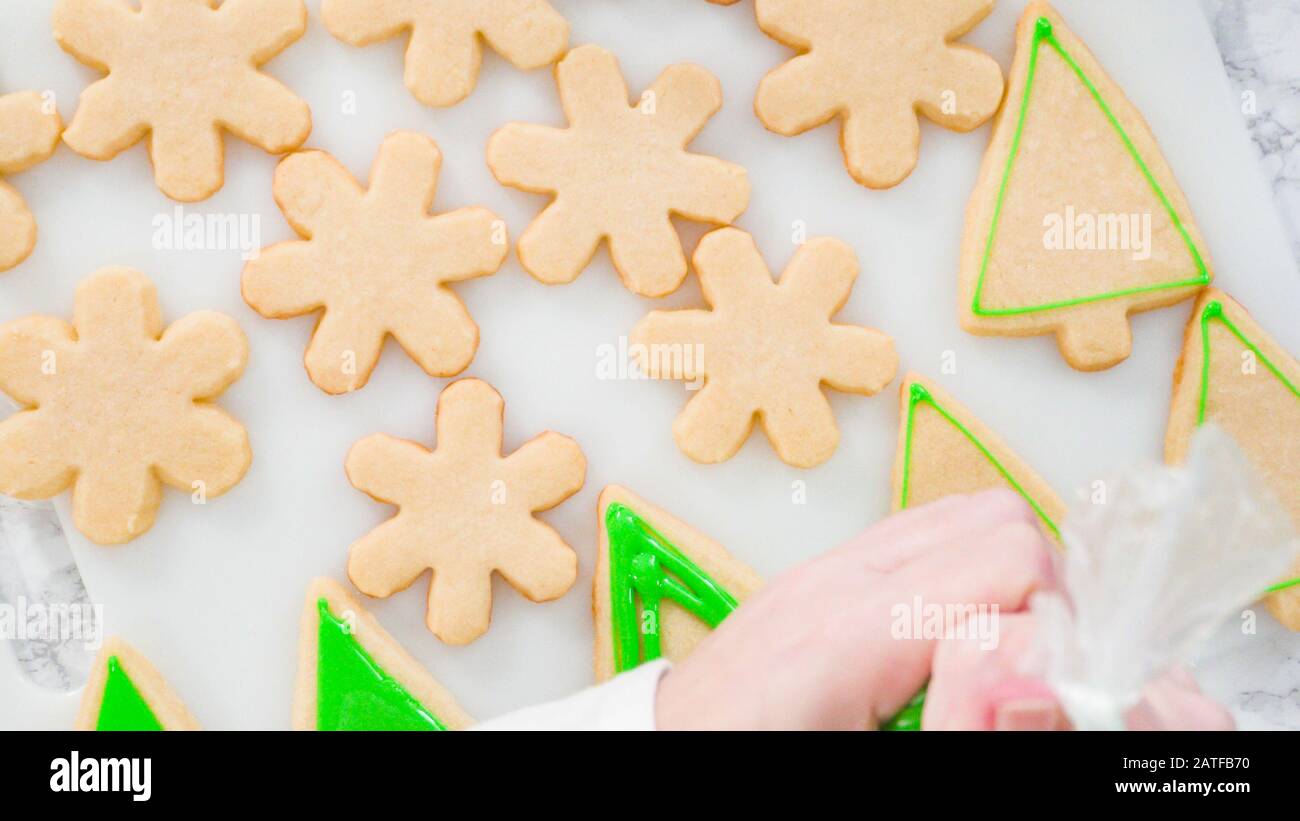 Flat lay. Stp by step. Icing Christmas tree-shaped sugar cookies with ...