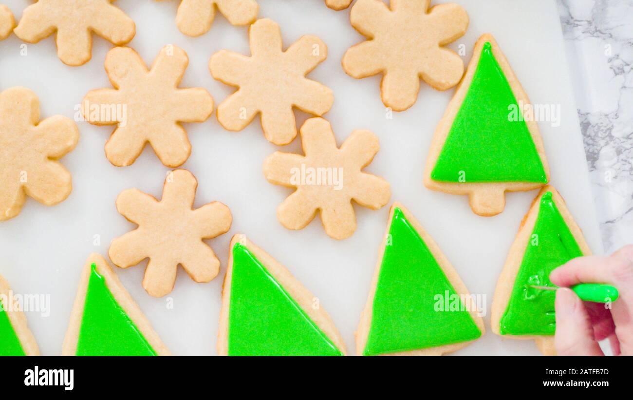 Flat lay. Stp by step. Icing Christmas tree-shaped sugar cookies with ...