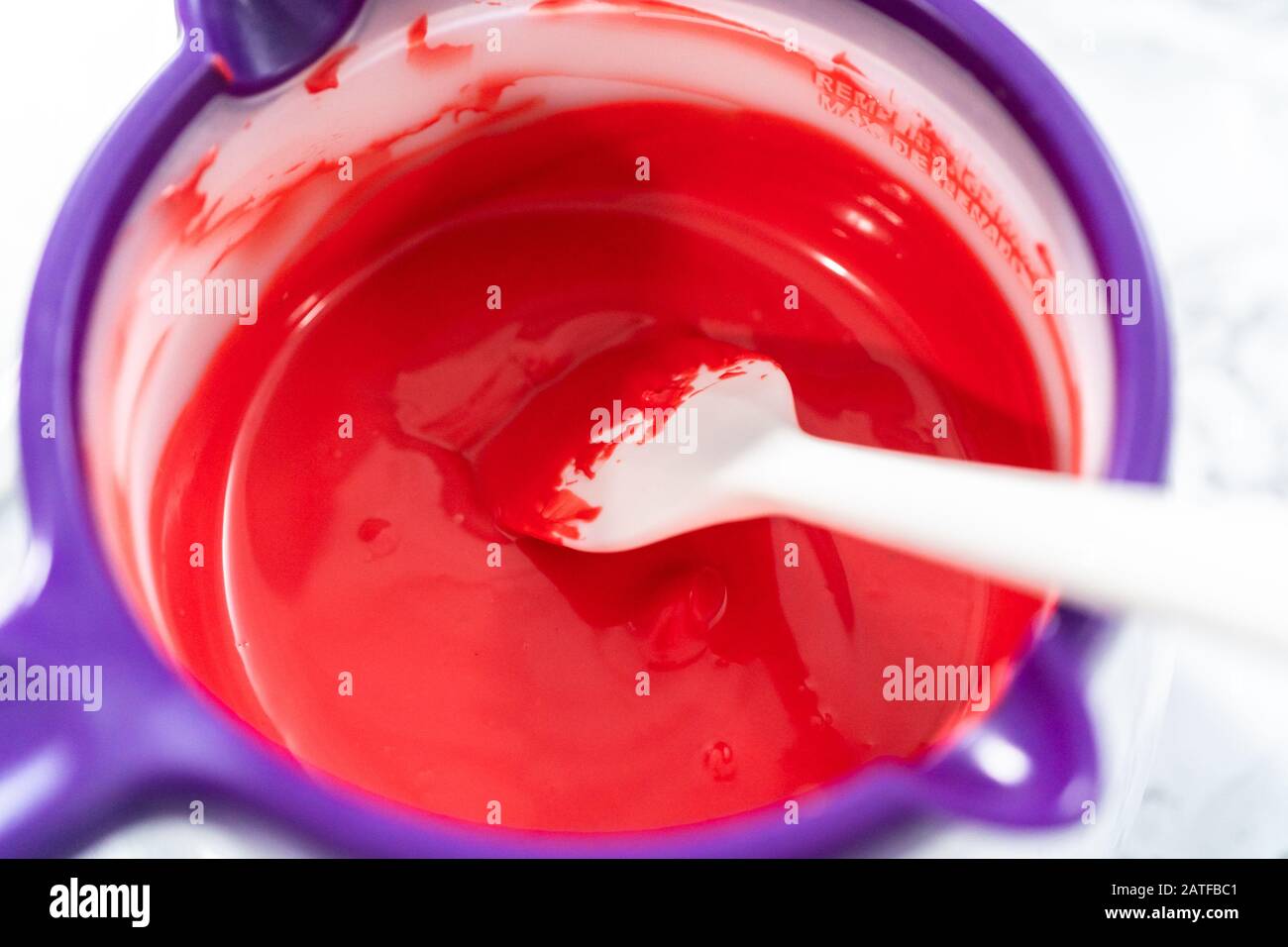 Melting red chocolate melts in the candy melting pot Stock Photo - Alamy