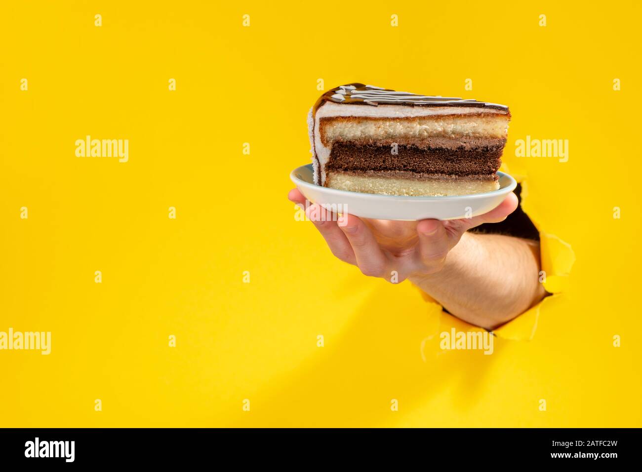 Hand giving a piece of chocolate cake Stock Photo - Alamy