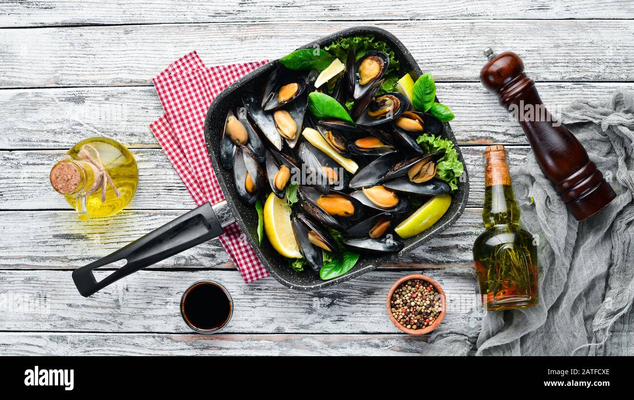 Fried mussels in a frying pan. Top view. Free space for your text. On ...
