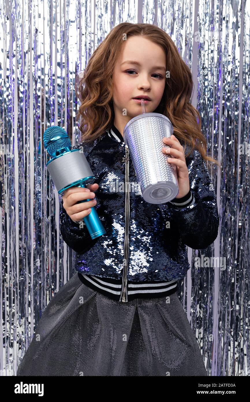 attractive caucasian girl in a talent contest with a microphone and a ...