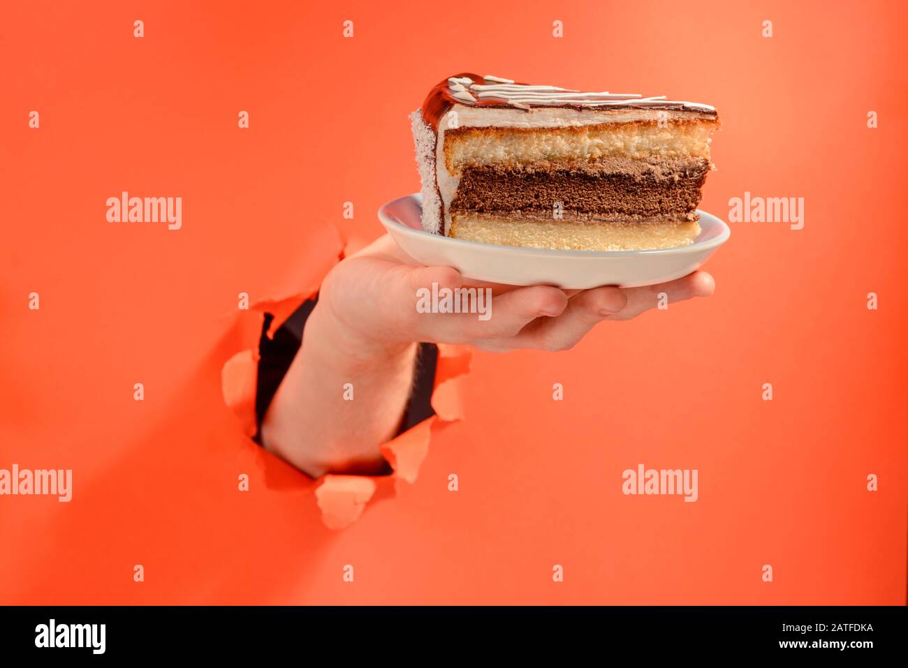 Hand giving a piece of chocolate cake Stock Photo - Alamy