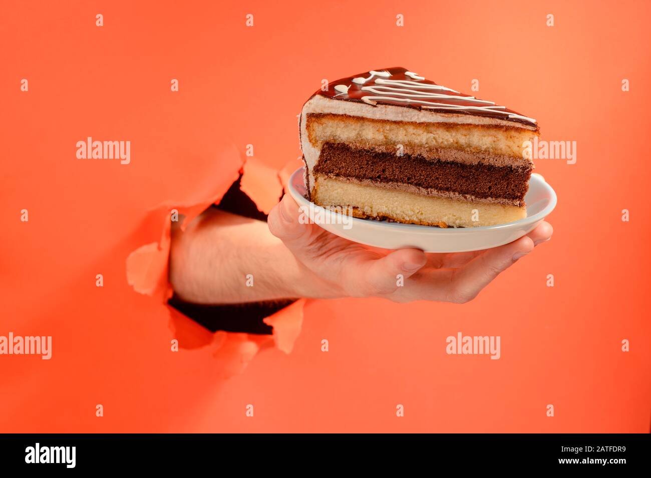 Hand giving a piece of chocolate cake Stock Photo - Alamy