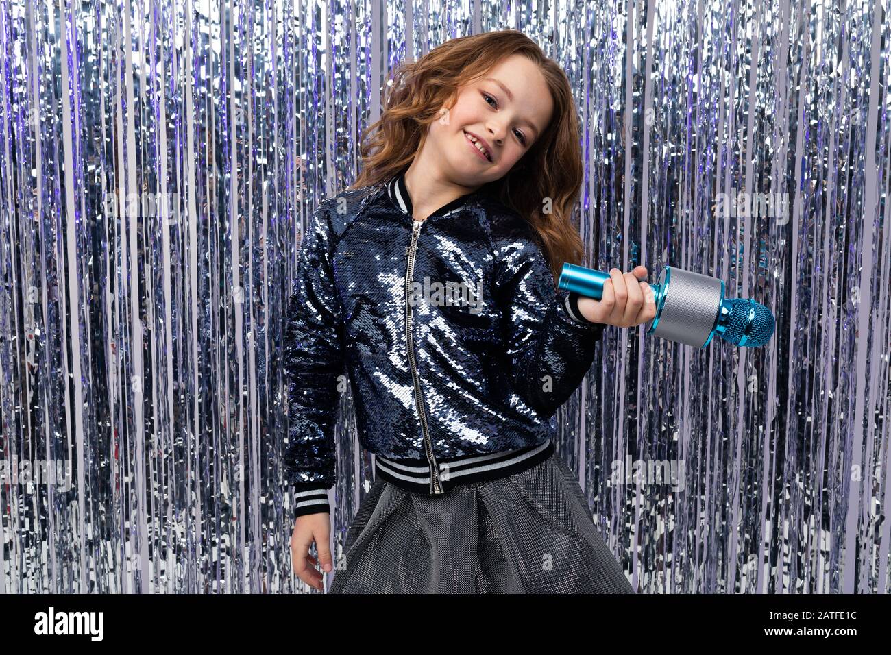 beautiful attractive girl in a talent contest with a microphone on a ...