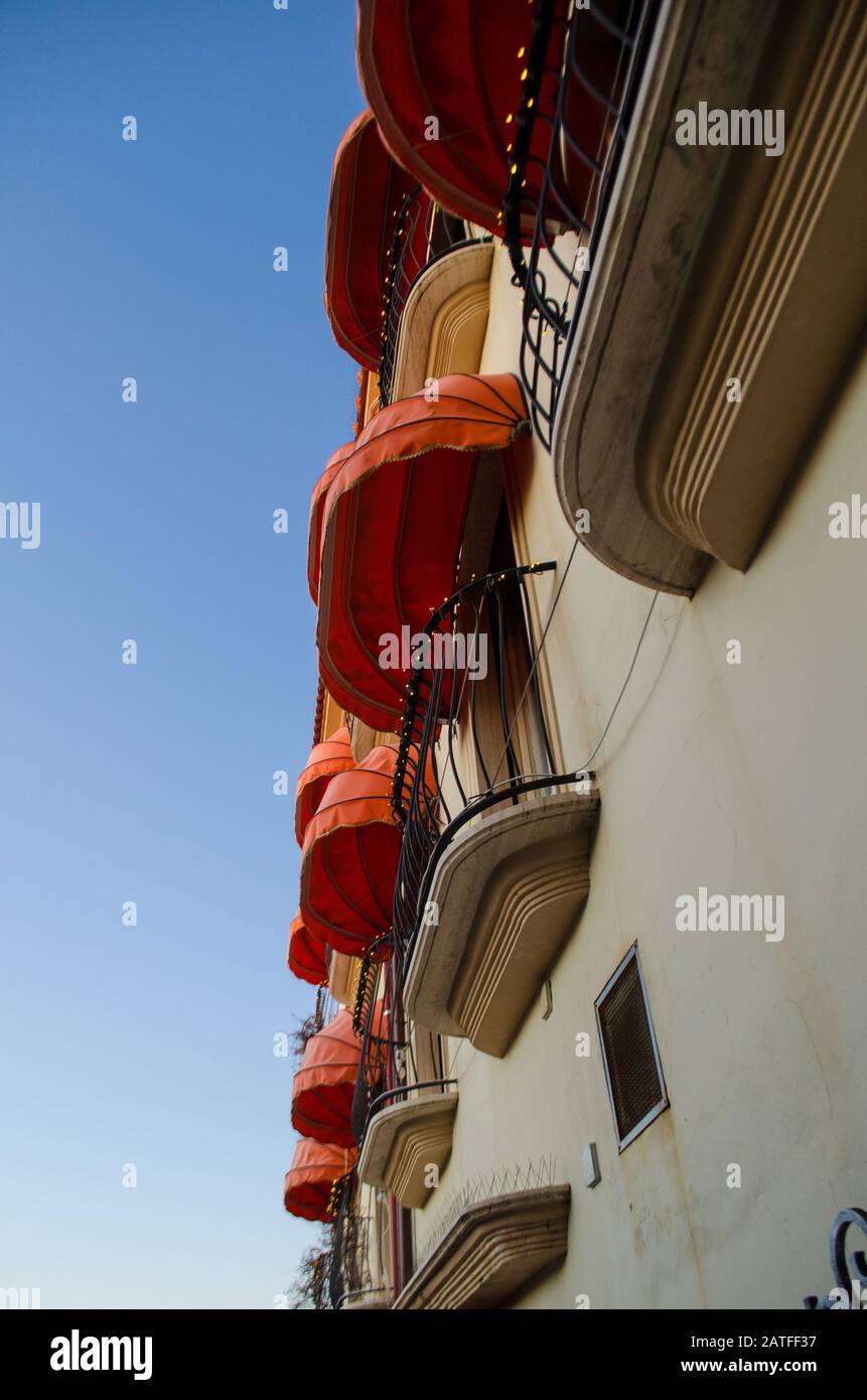 Red balcony canopy on white building Stock Photo - Alamy
