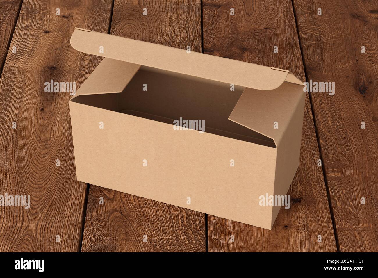 Blank cardboard wide box with opened hinged flap lid on dark wooden ...