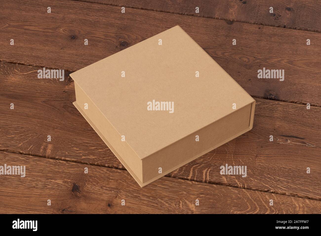 Blank cardboard flat square gift box with closed hinged flap lid on ...