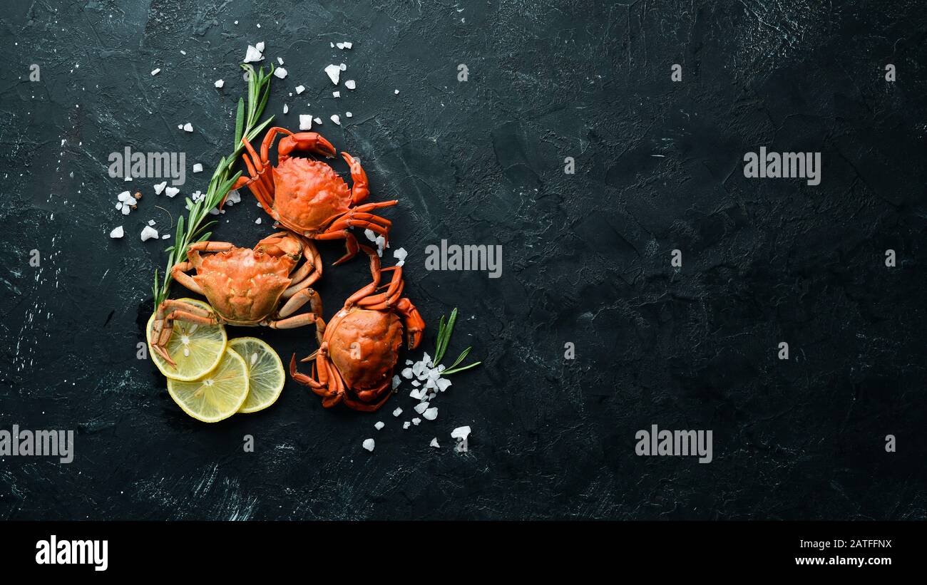 Seafood. Boiled crabs. Top view. On a black stone background Stock ...
