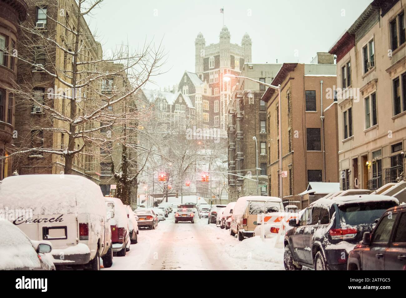 Snow-covered street and cars on a cold and dreary winter's day, Harlem ...