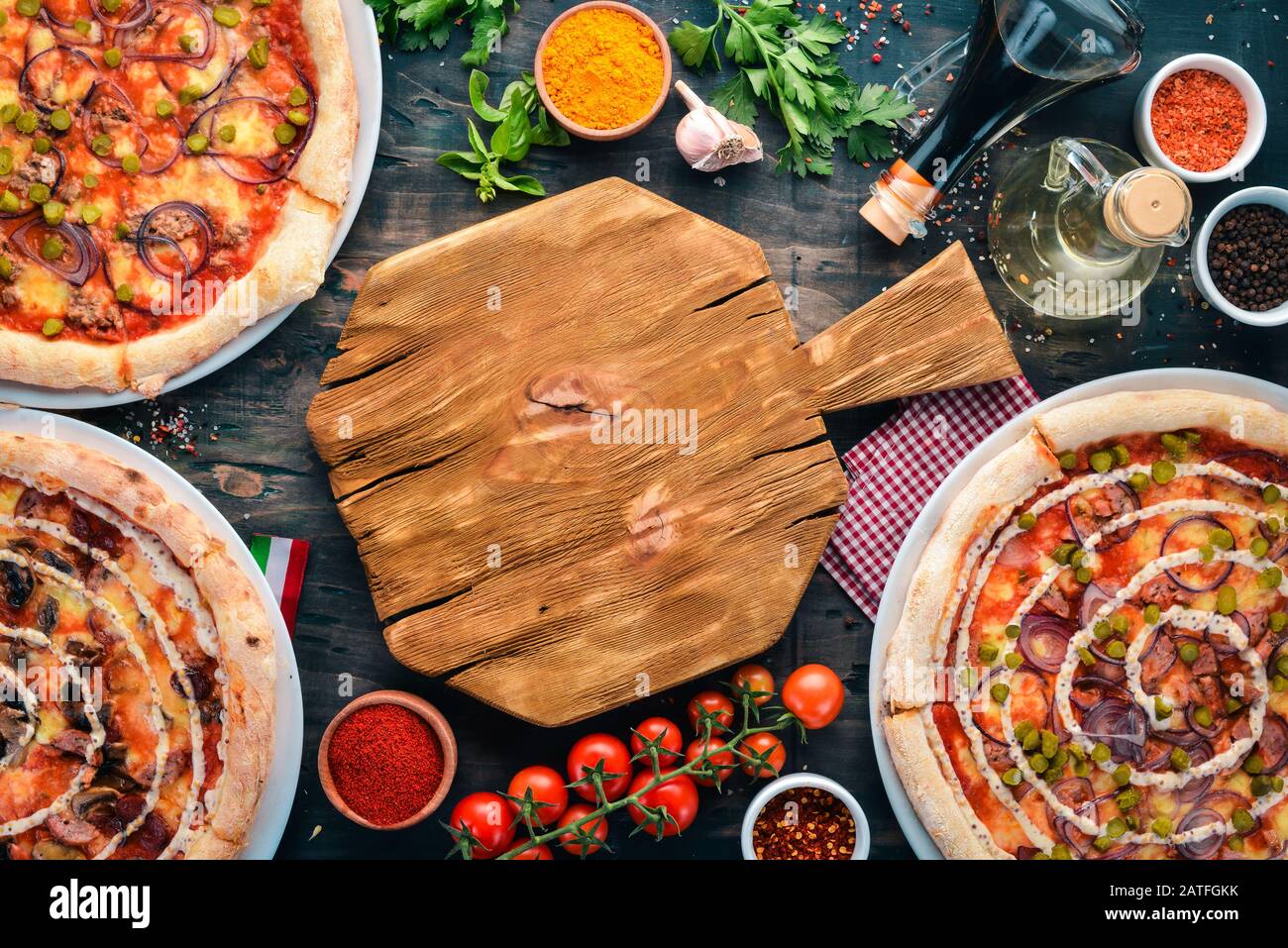 A set of Italian pizza. Italian cuisine. On a black wooden background ...