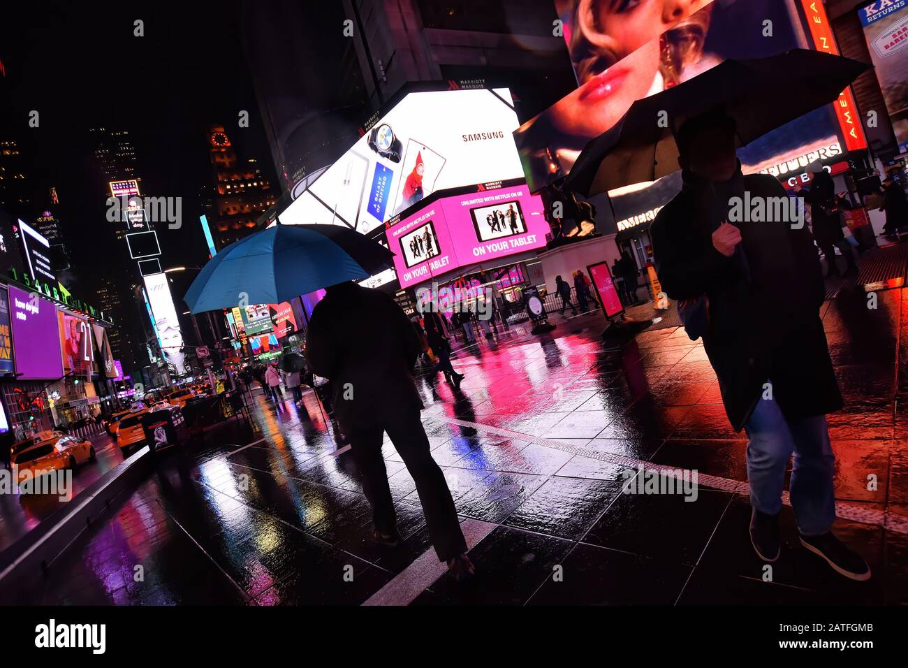 Winter rainy night on Broadway at Times Square, tourist destination ...