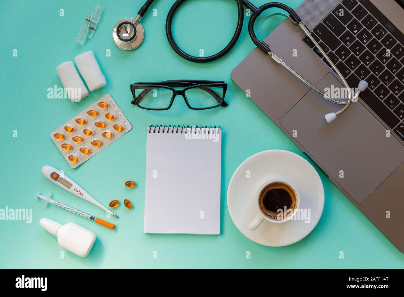 Doctor desk table with stethoscope and laptop computer. Top view with ...