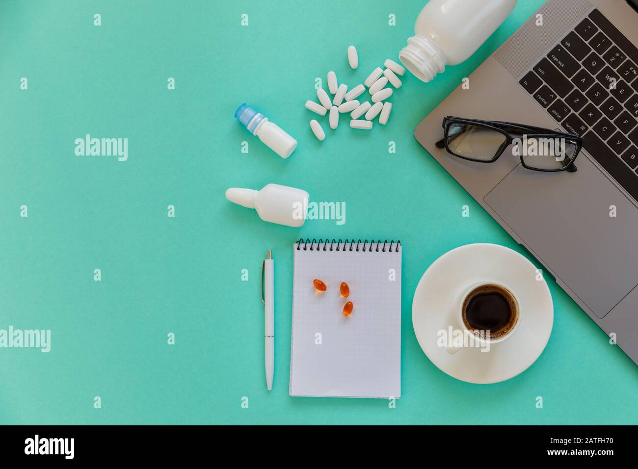 Doctor desk table with stethoscope and laptop computer. Top view with ...