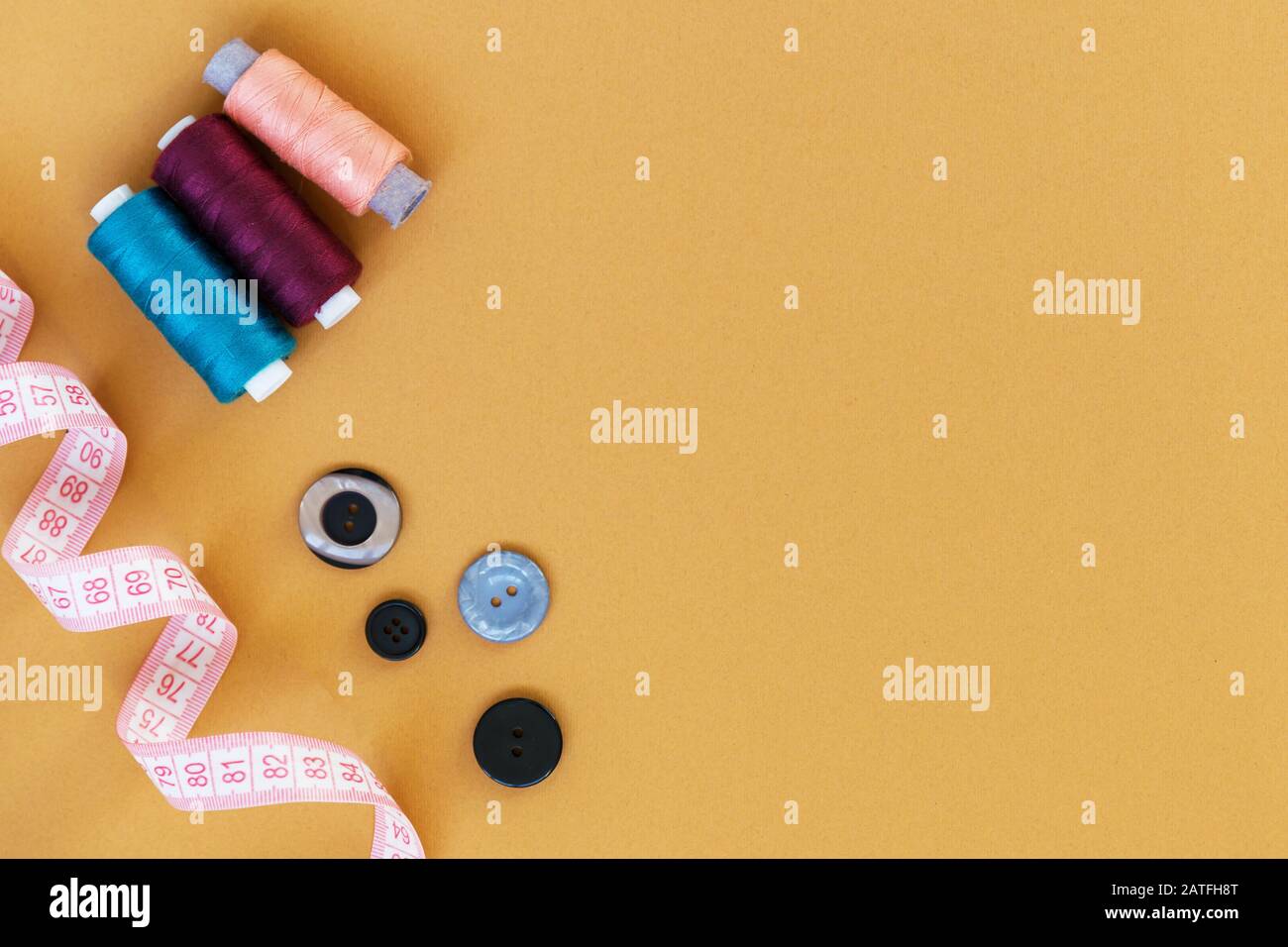 Group of sewing objects lying flat on a colorful background. Horizontal ...