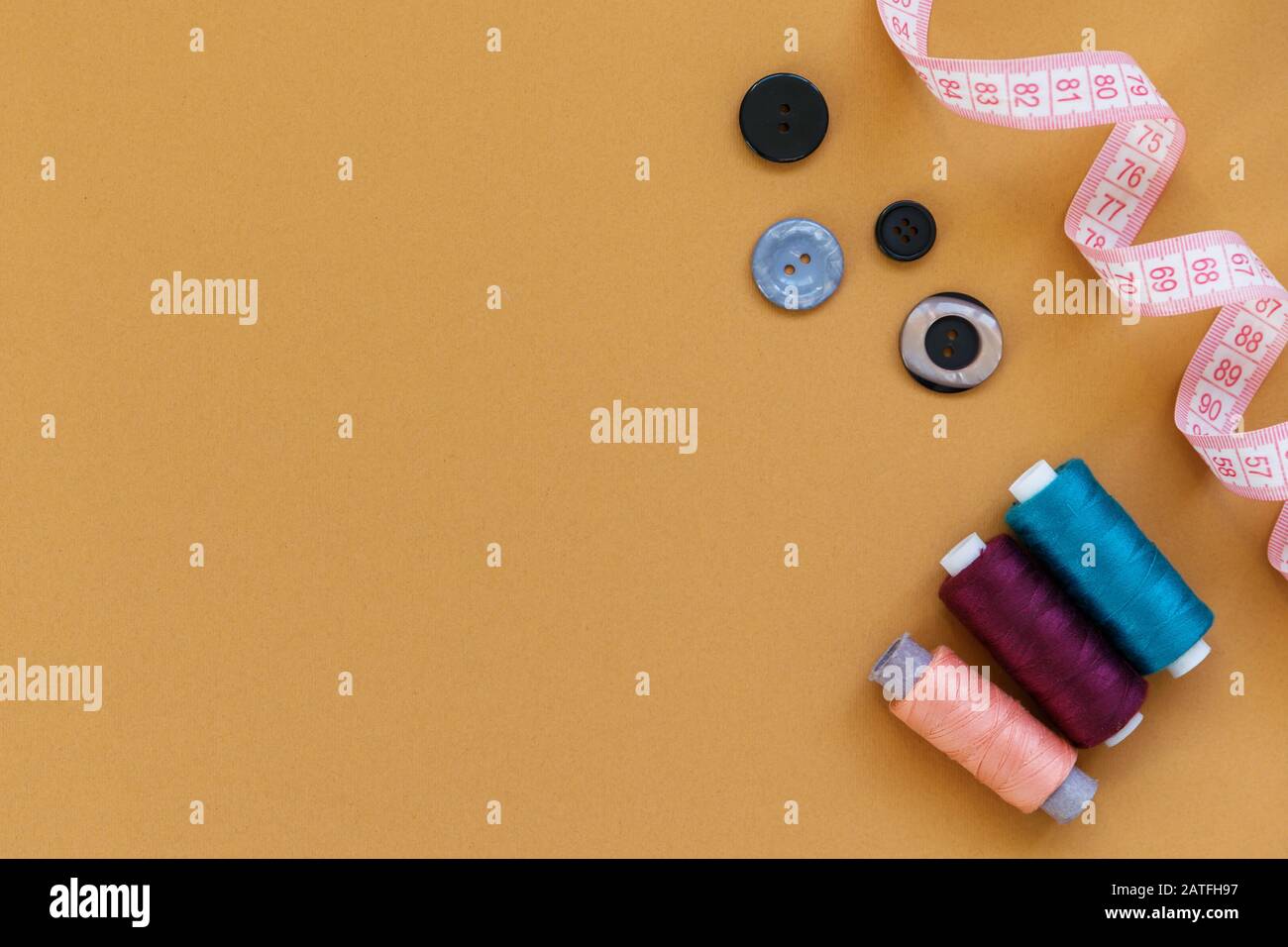 Group of sewing objects lying flat on a colorful background. Horizontal ...