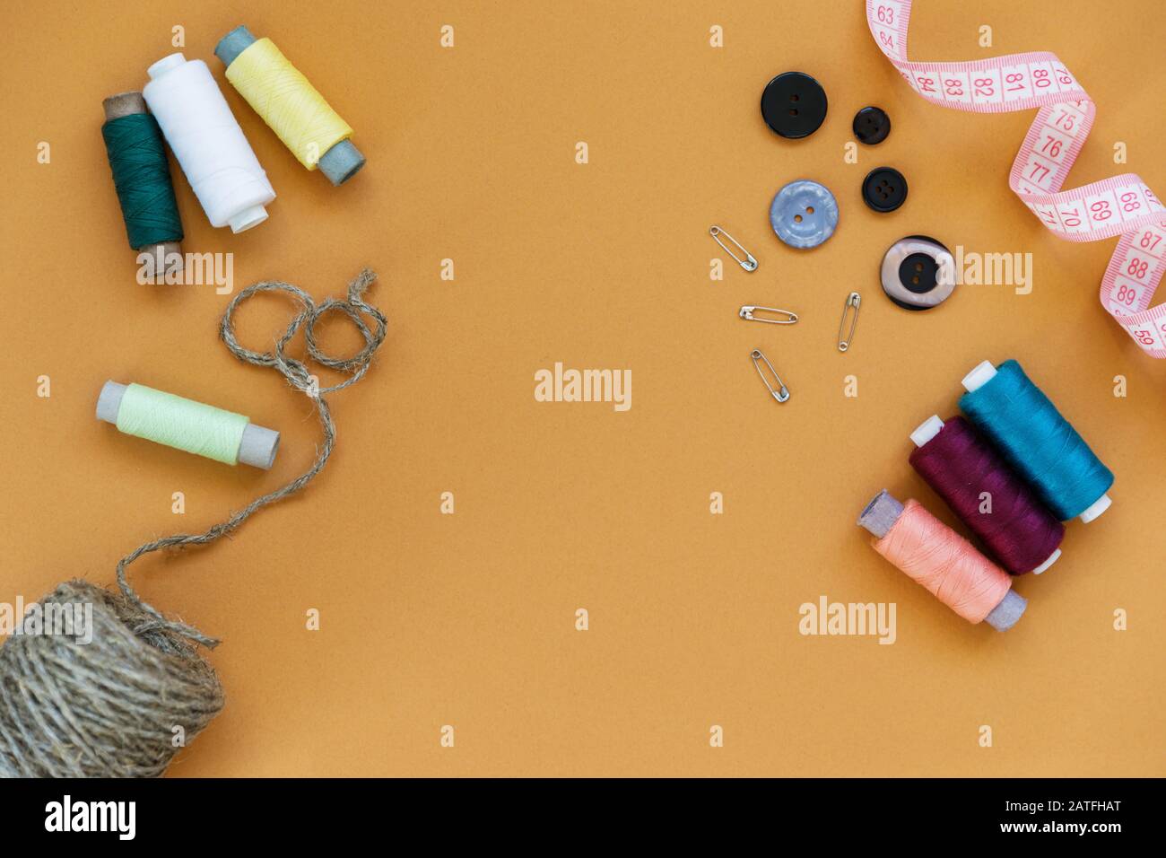 Group of sewing objects lying flat on a colorful background. Horizontal ...