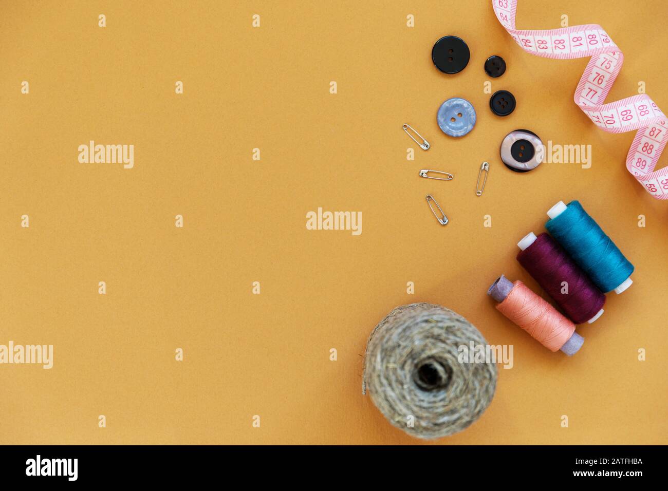 Group of sewing objects lying flat on a colorful background. Horizontal ...