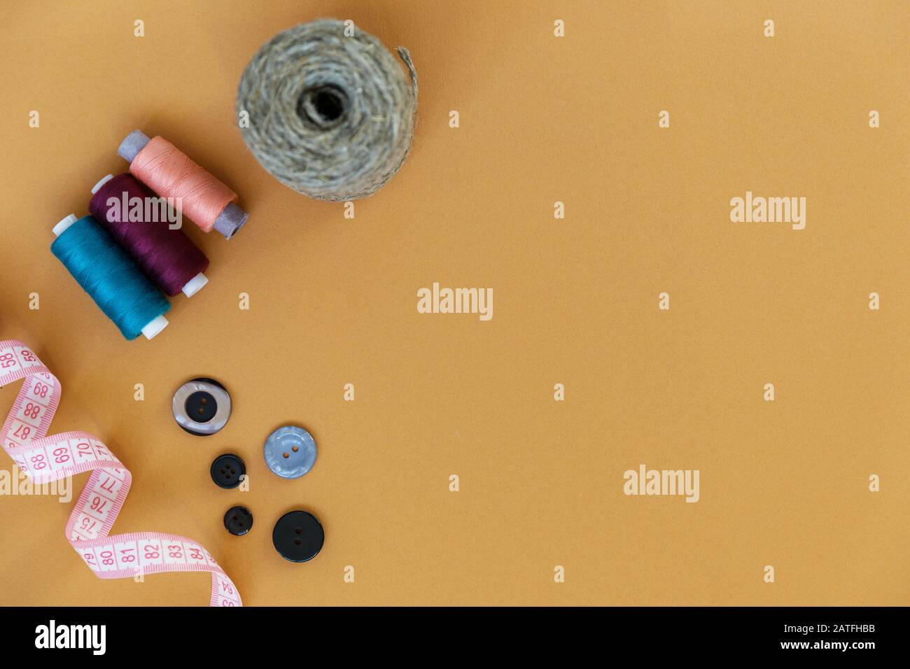 Group of sewing objects lying flat on a colorful background. Horizontal ...