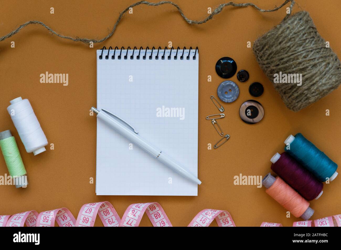 Group of sewing objects lying flat on a colorful background. Horizontal ...