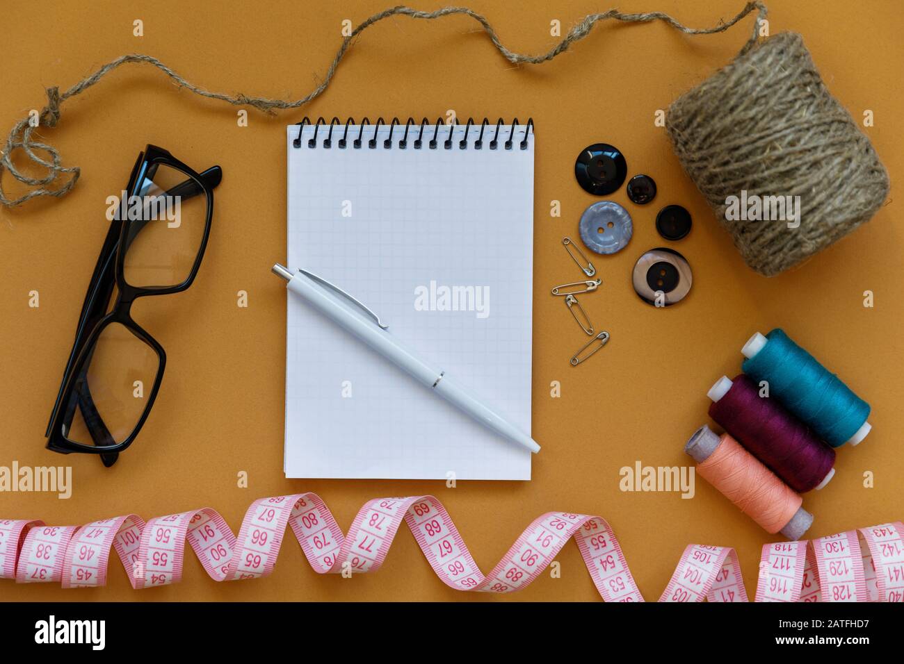 Group of sewing objects lying flat on a colorful background. Horizontal ...