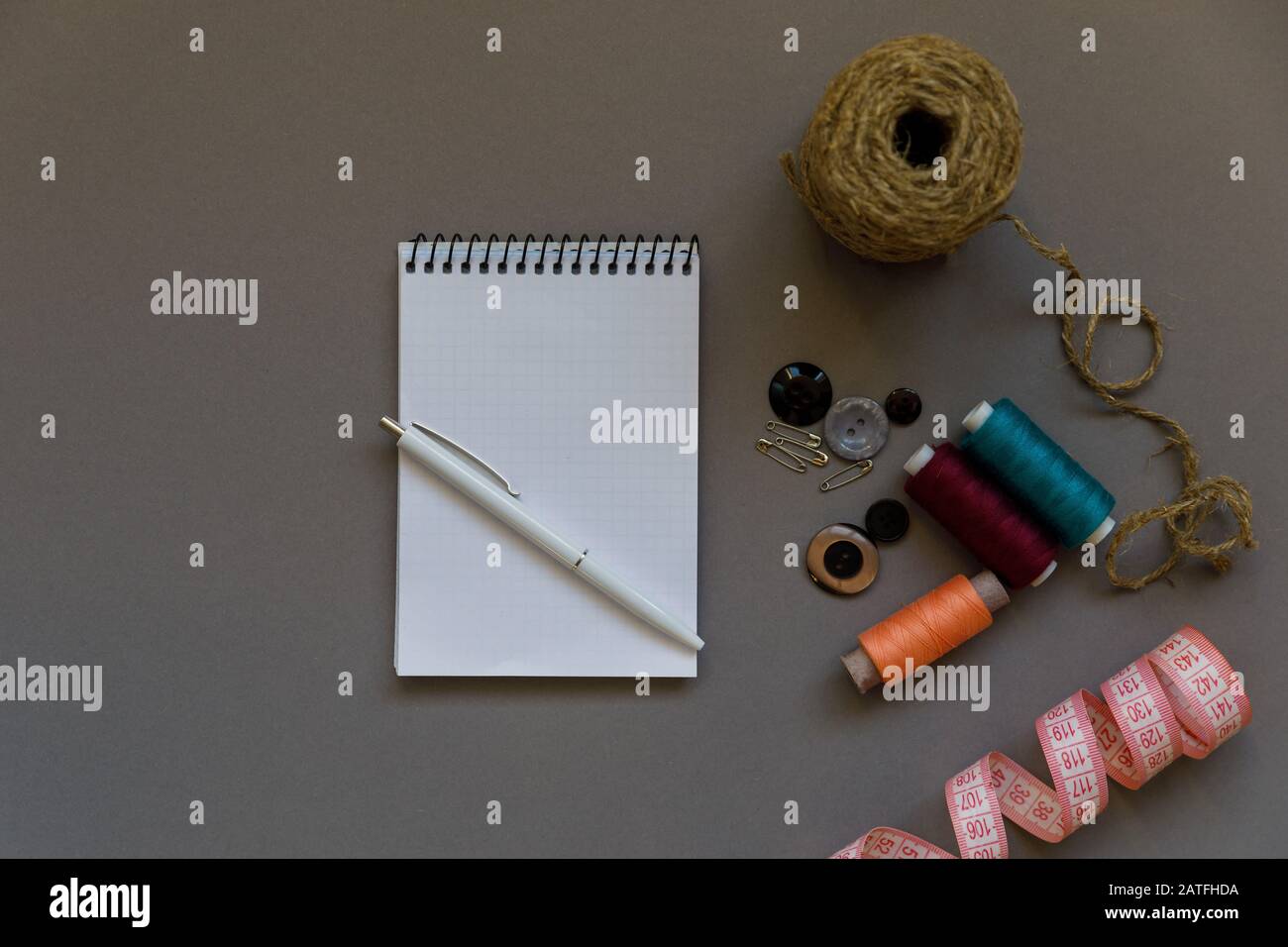 Group of sewing objects lying flat on a colorful background. Horizontal ...