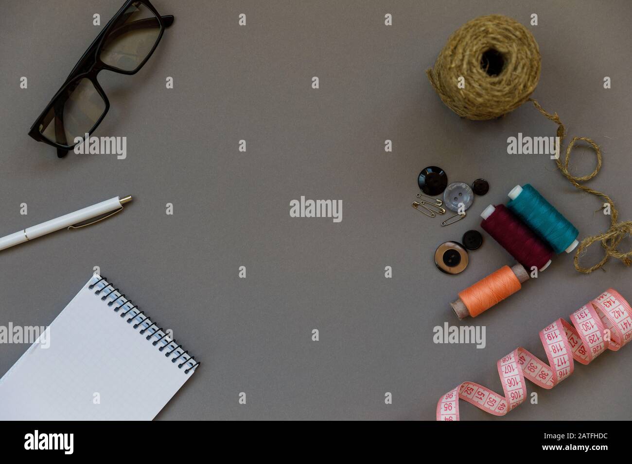 Group of sewing objects lying flat on a colorful background. Horizontal ...