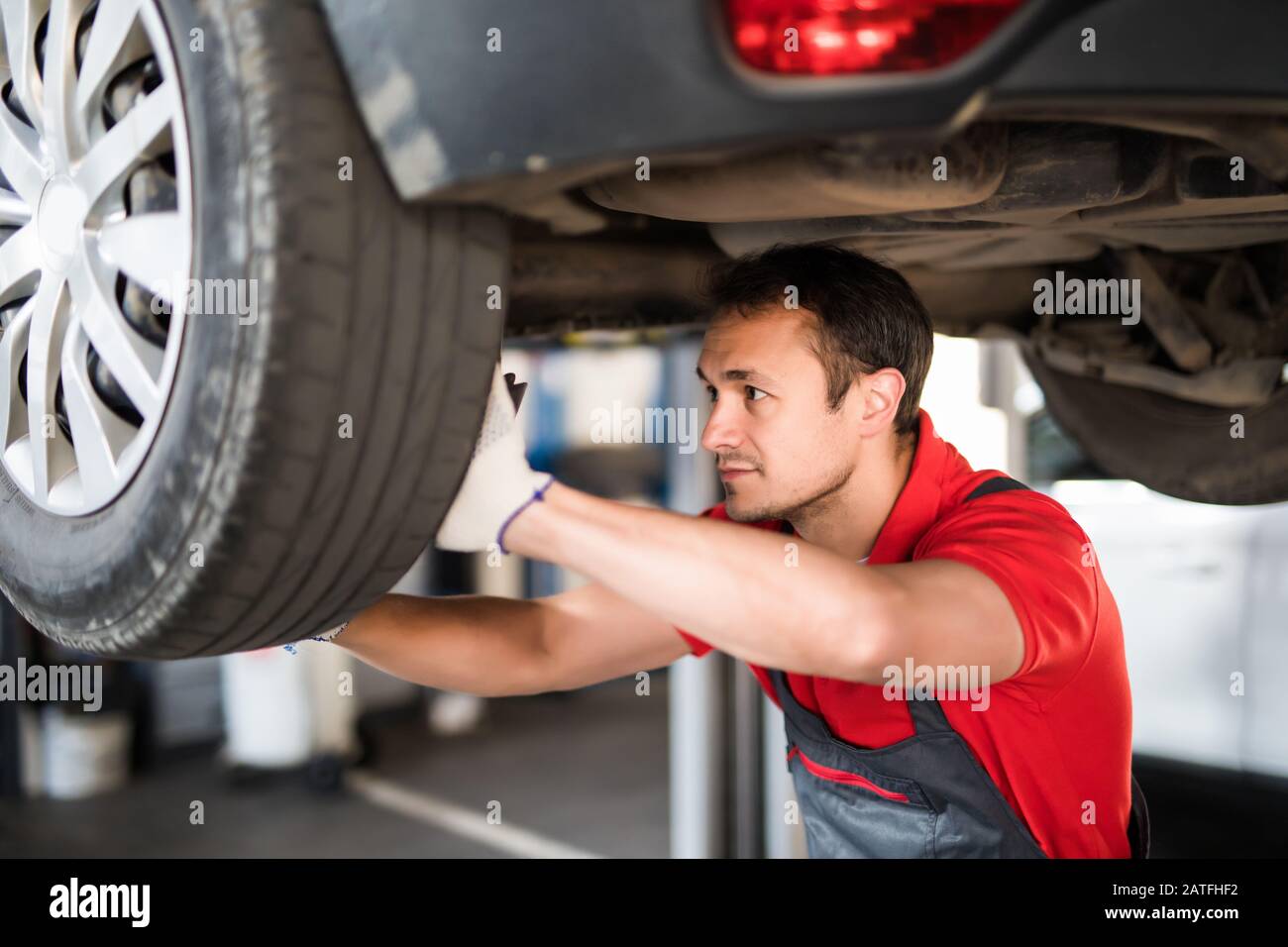 mechanic with tool checking the car Stock Photo - Alamy