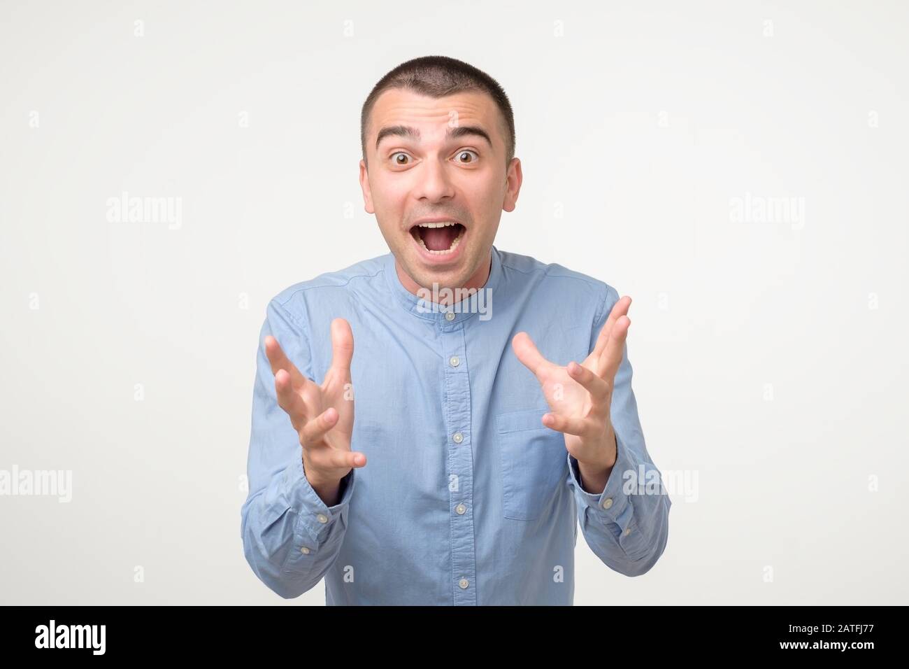 Achievement, success concept. Cheerful hispanic man raising his hands ...